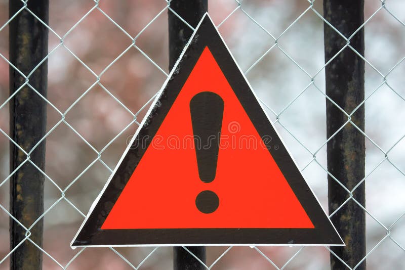 Warning Sign in the Form of a Triangle on a Metal Mesh Fence Stock ...
