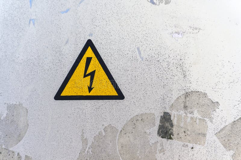 Warning Sign Indicating Electrical Hazard on a Textured Surface in an ...