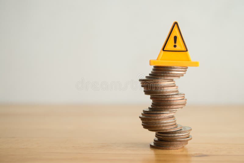 Warning Sign Label on Stack Coins in Uncertainty Situation on Wooden ...