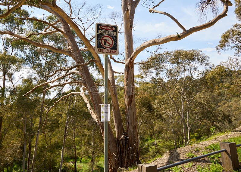 Warning Sign Near the Edge of a Cliff Placed by a Tree Stock Photo ...