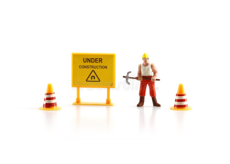 Warning Sign Under Construction with Miniature Figure Labo Stock Photo ...
