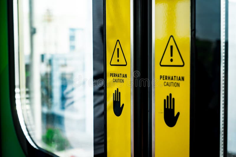Warning Signs with Hands Symbol on Doors of Indonesia Commuter Train ...