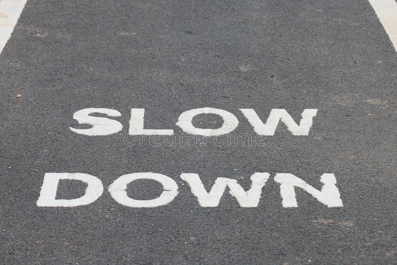A Warnning Sign SLOW DOWN Painted on the Bike Lane Stock Photo - Image ...