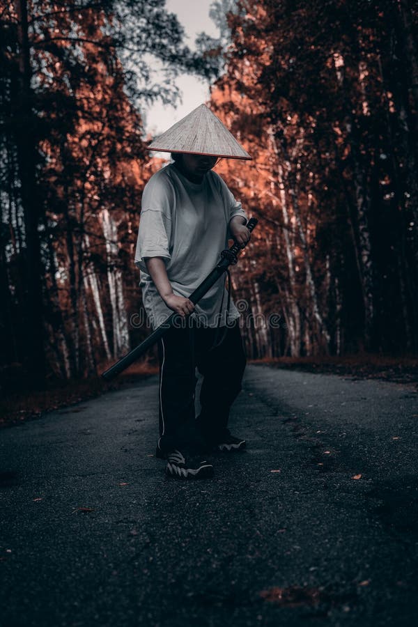 A Warrior Stands on a Path in the Forest, Holding a Katana in Both ...