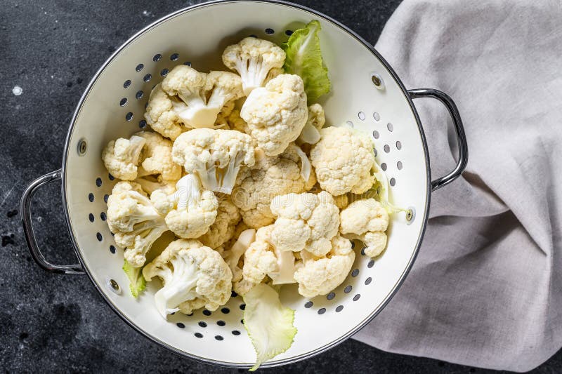 Washed Fresh Cauliflower Cut into Pieces in a Colander. Black ...