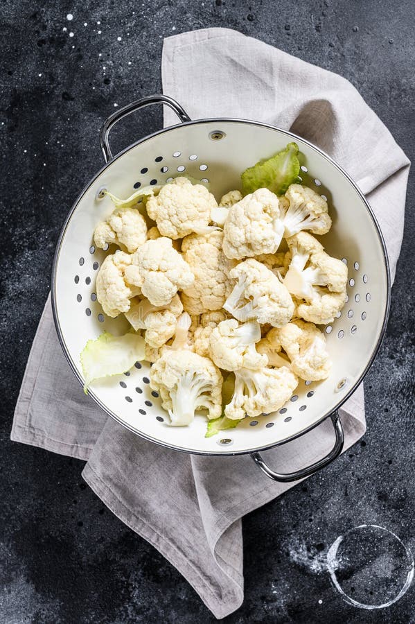 Washed Fresh Cauliflower Cut into Pieces in a Colander. Black ...