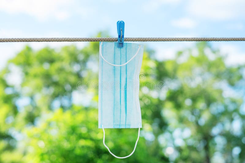 The Washed Protective Mask is Dried on a Clothesline on a Sunny Summer ...