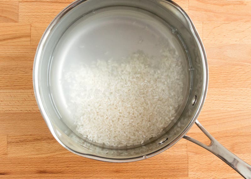Washed Rice Lies in a Bowl in Water Stock Photo - Image of ladle, stir ...