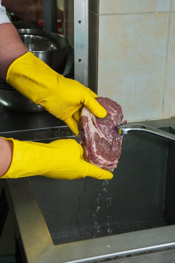 Washing and cleaning meat stock image. Image of meat - 76244577