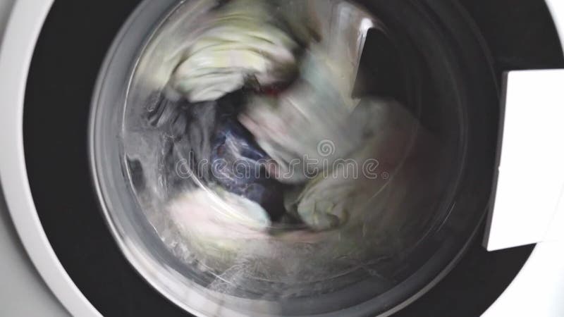 Washing Clothes in Washing Machine, Washing Process is Visible through ...