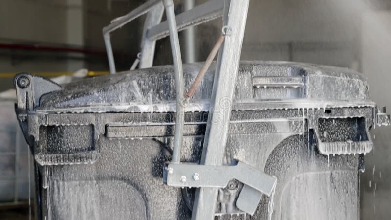 Washing the Container. the Garbage Can is Treated with a Special Foam ...
