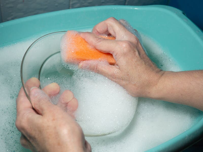 Washing Dishes by Hand. Washing the Plate with a Foam Sponge Stock ...