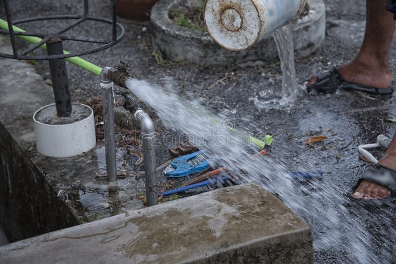 Washing Hand,legs and Plumbing Tools with the Burst Water Pipe ...