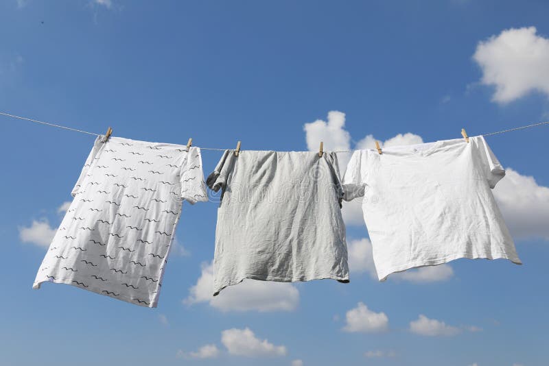 Washing Line with Clean Clothes Against Sky. Drying Laundry Outside ...