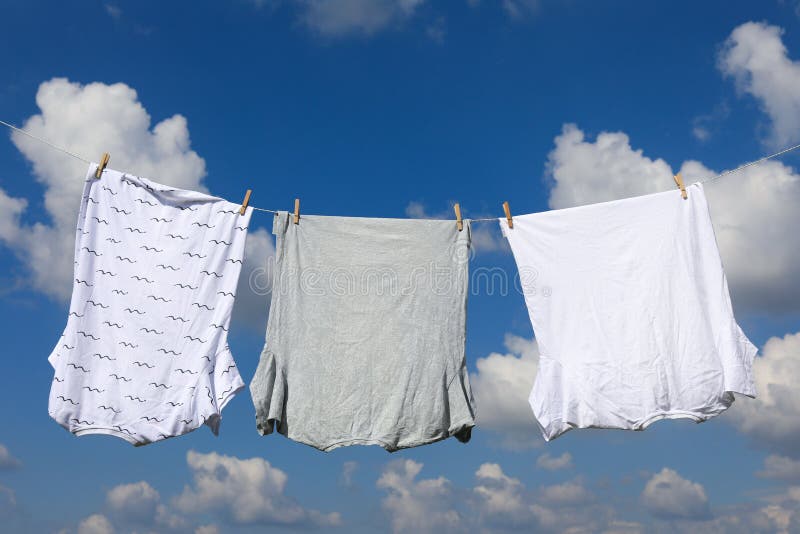 Washing Line with Clean Clothes Against Sky. Drying Laundry Outside ...