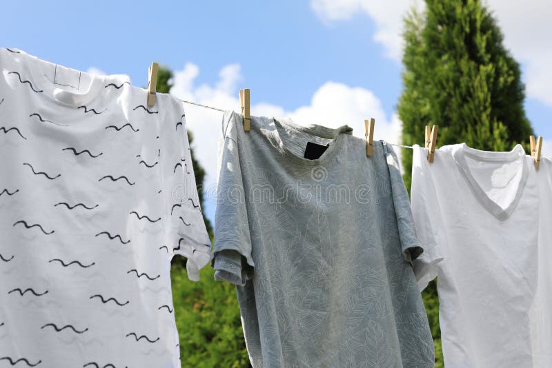 Washing Line with Clean Clothes Outdoors. Drying Laundry Outside Stock ...