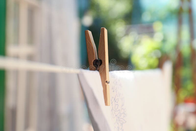 Washing Line with Clean Laundry and Clothespin Outdoors, Closeup Stock ...