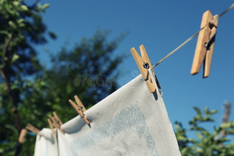 Washing Line with Clean Laundry and Clothespins Outdoors, Closeup Stock ...