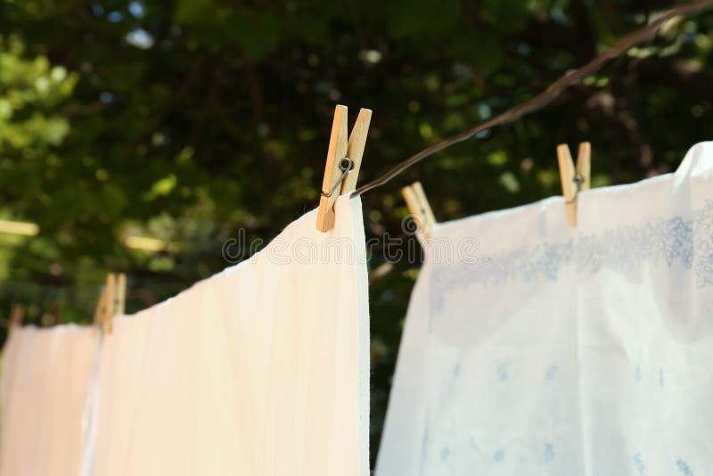 Washing Line with Clean Laundry and Clothespins Outdoors Stock Photo ...