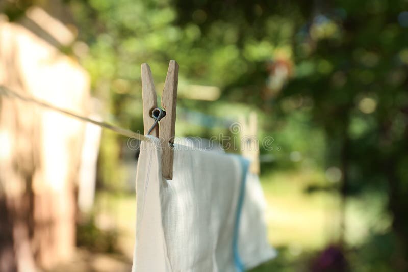 Washing Line with Clean Laundry and Clothespins Outdoors, Closeup ...