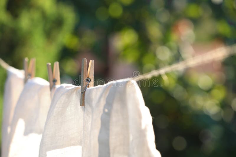 Washing Line with Drying Shirt Against Blurred Background, Focus on ...