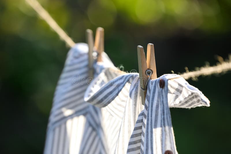 Washing Line with Drying Shirt Against Blurred Background, Focus on ...