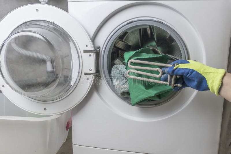 Washing Machine Breakdown. the Master Retrieves the Floor Part. in the ...