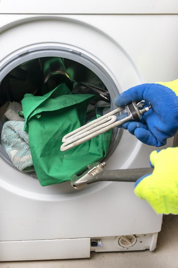 Washing Machine Breakdown. the Master Retrieves the Floor Part. in the ...