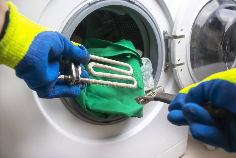 Washing Machine Breakdown. The Master Retrieves The Floor Part. In The ...