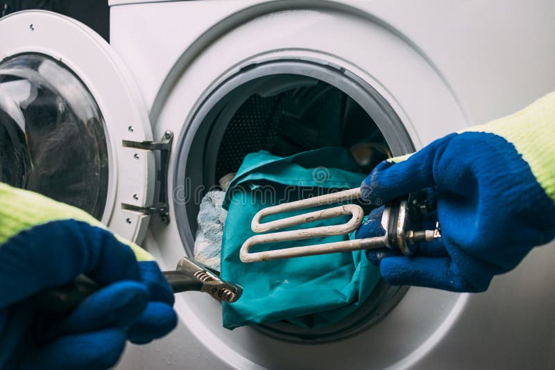 Washing Machine Breakdown. the Master Retrieves the Floor Part. in the ...