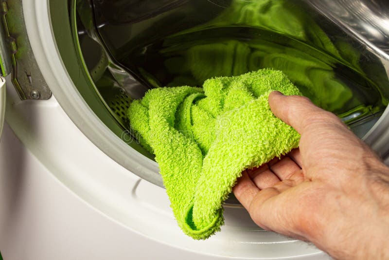 Washing Machine with the Door Ajar and Manual Laying of Clothes Inside ...