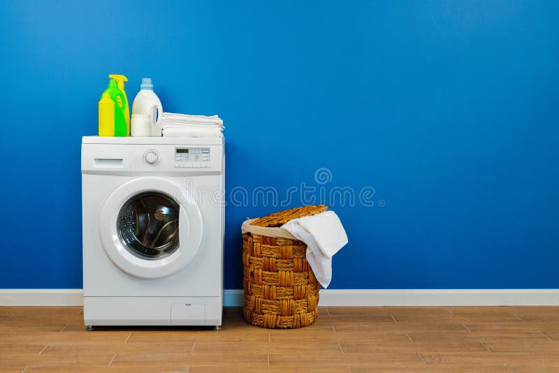 Washing Machine with Laundry on Blue Wall Background Stock Image ...