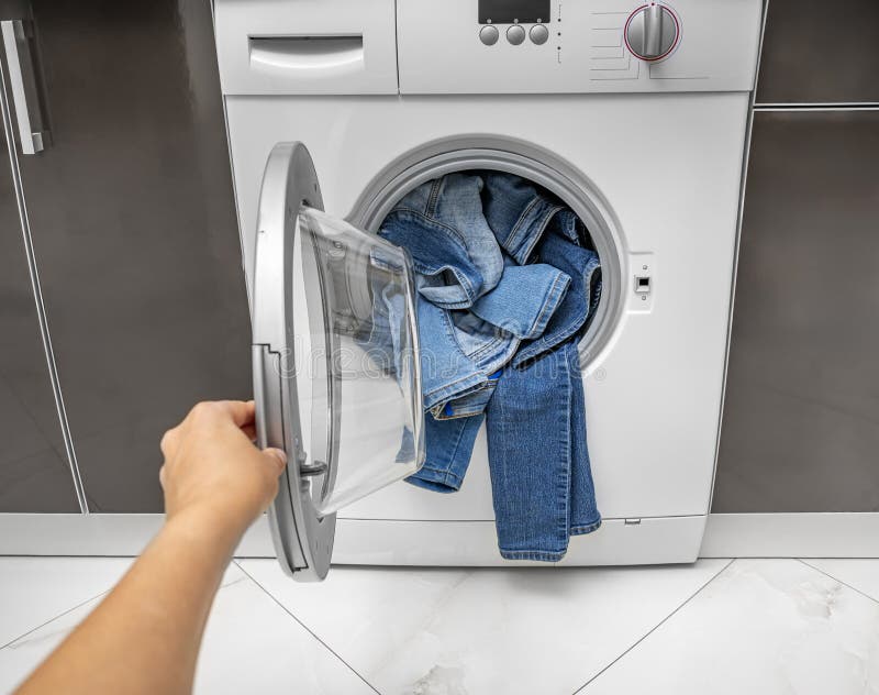 Washing Machine Overflowing with Clothes. Stock Photo - Image of ...