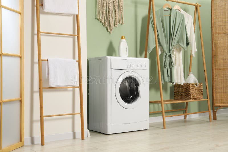Washing Machine, Towels and Detergent in Laundry Room Stock Photo ...