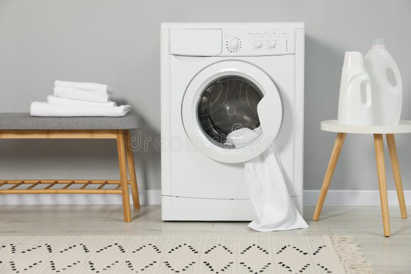 Washing Machine, Towels and Detergents Near Grey Wall Stock Image ...