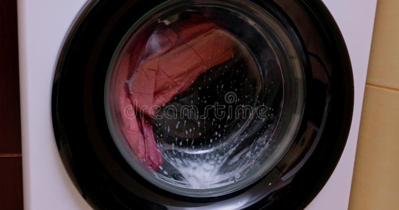 A Washing Machine Working with Laundry in Action, Unfolding the daily ...