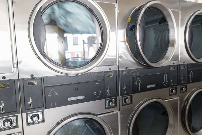 Washing Machines with Clothes Inside at Laundromat Stock Image - Image ...