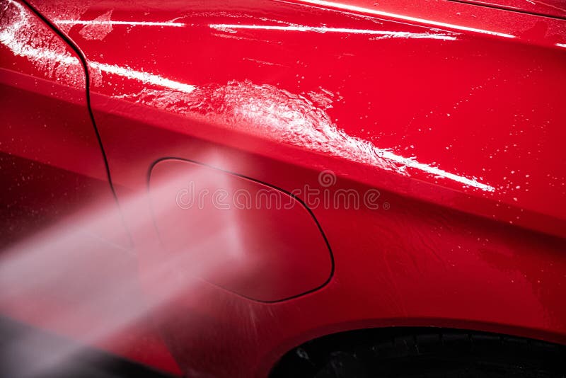 Washing a Modern Red Car at a Car Wash Using a Pressure Washer Stock ...