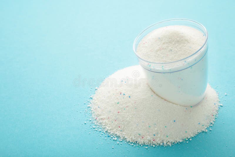 Washing Powder in a Measuring Cup on a Blue Background Stock Photo ...