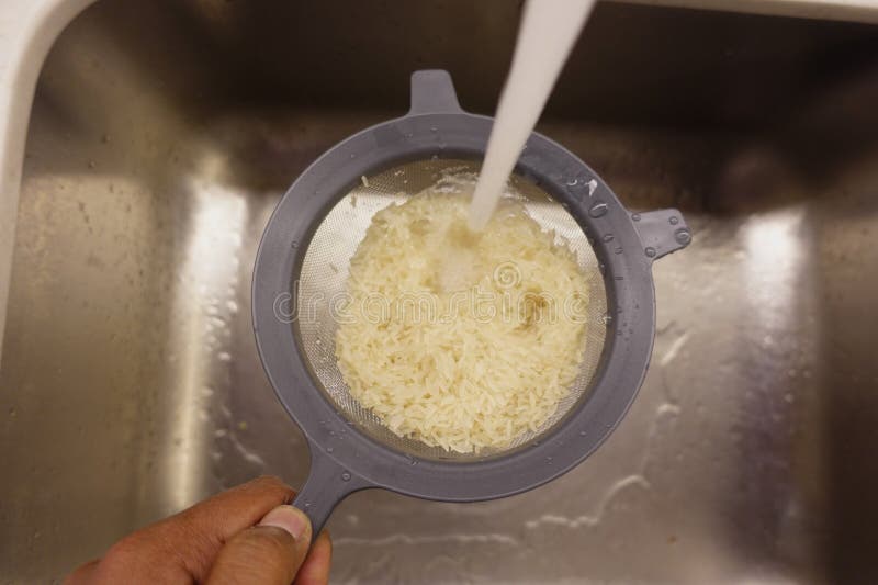 Washing Rice in a Kitchen Sink with a Strainer in Daylight Stock Image ...