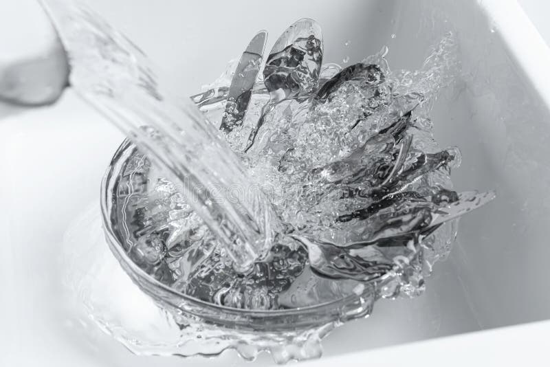 Washing Silver Kitchenware Under Stream of Water in Sink, Above View ...