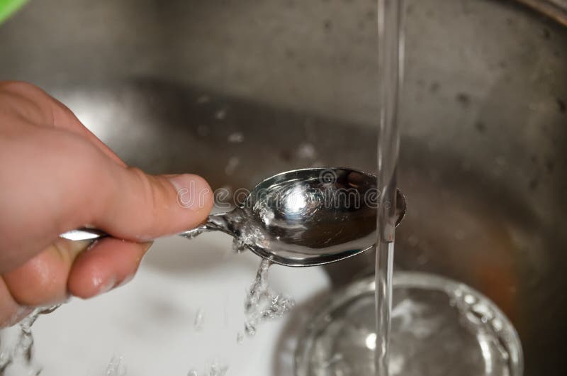 Washing a spoon with soap stock image. Image of concept - 146788305