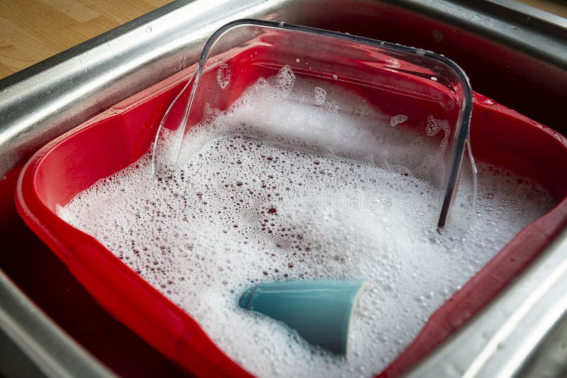 Washing Up in a Red Washing Up Bowl Stock Photo - Image of items, glass ...