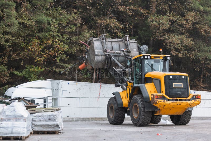 Waste Loading Operation, Loader Dumping Trash in a Truck Stock Image ...