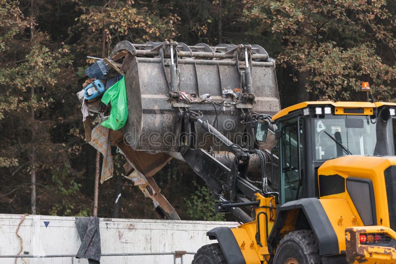 Waste Loading Operation, Loader Dumping Trash in a Truck Stock Image ...