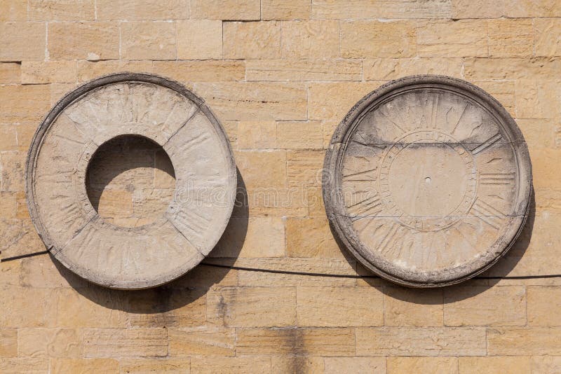 Watch Dials Attached To a Stone Wall Stock Photo - Image of object ...