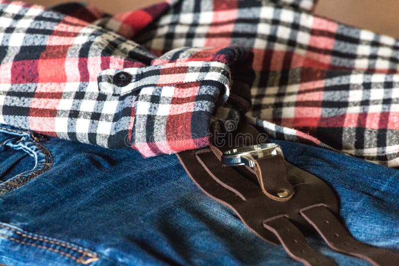 Watch, Jeans and Checkered Shirt Close-up on the Table. Stock Photo ...