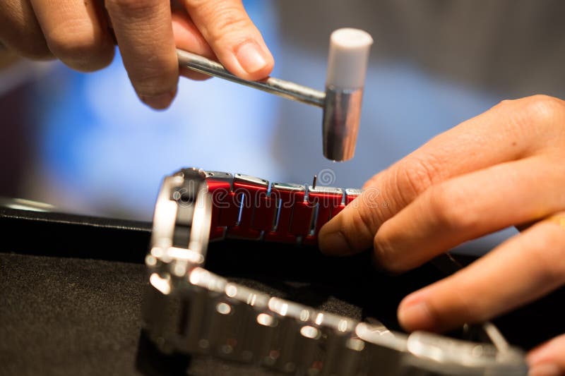 A Watch Pin Being Installed into the Watch Band with a Hammer and a ...