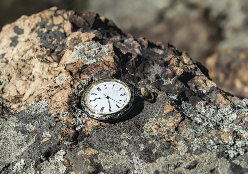 Watch on rocks stock image. Image of hour, conceptual - 45410943