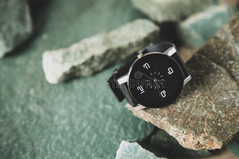 Watch on the stones stock photo. Image of elegant, clock - 260866686